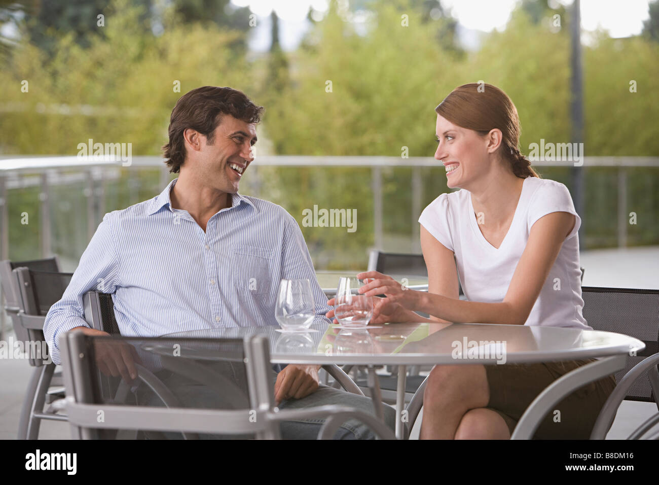 Smiling couple at dining table Stock Photo - Alamy