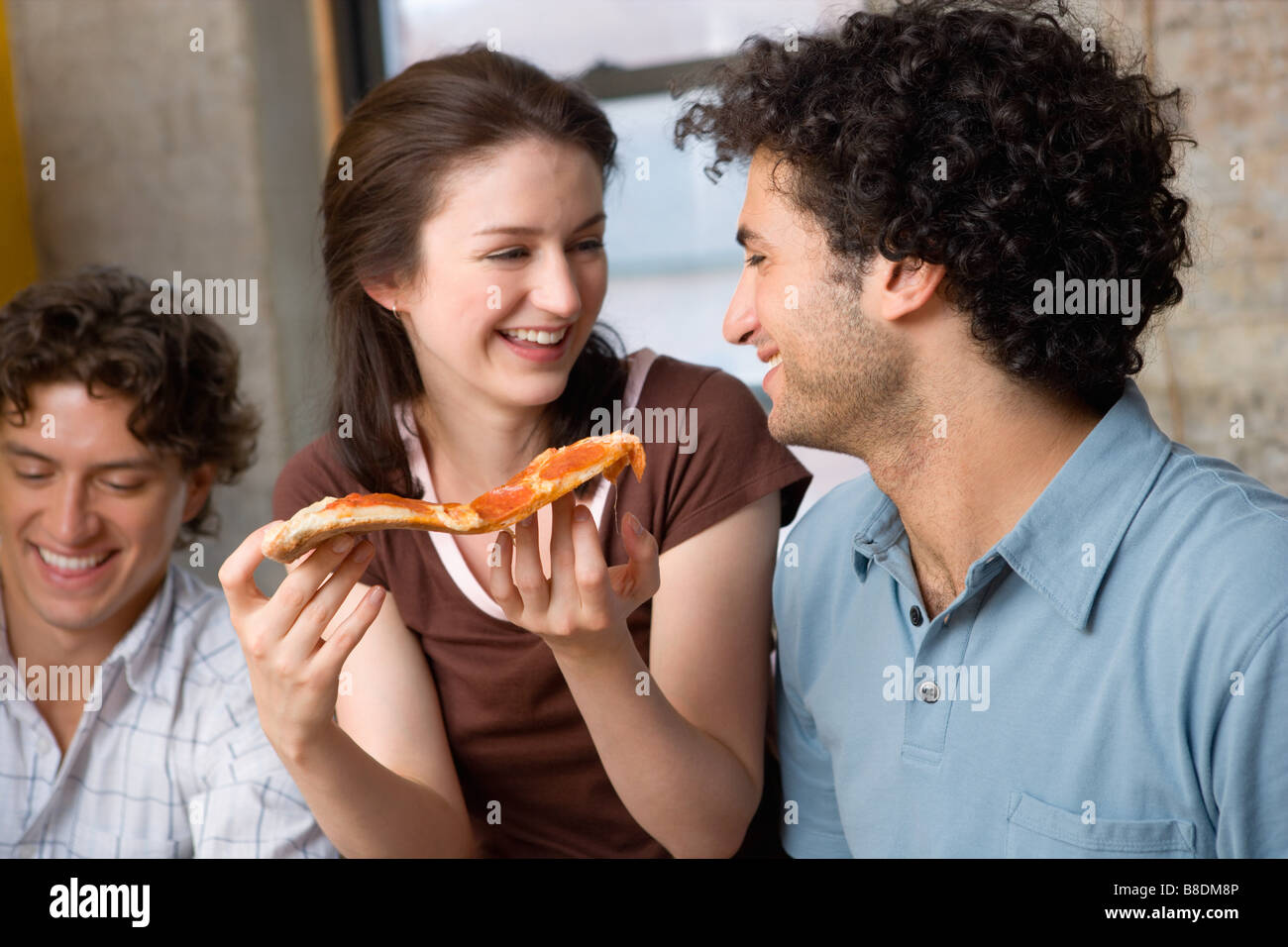 Friends eating pizza Stock Photo - Alamy