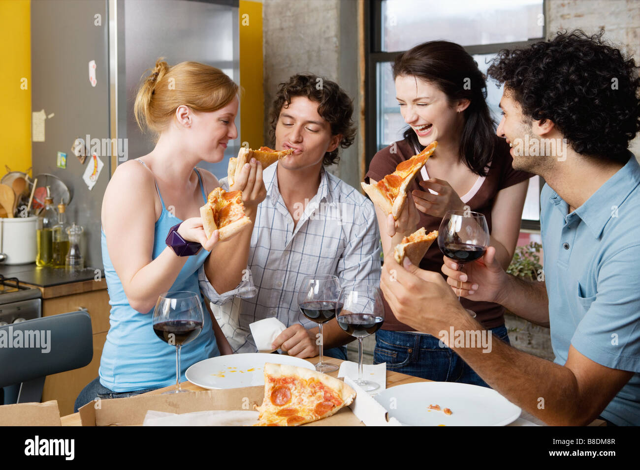 Four friends sharing pizza hi-res stock photography and images - Alamy