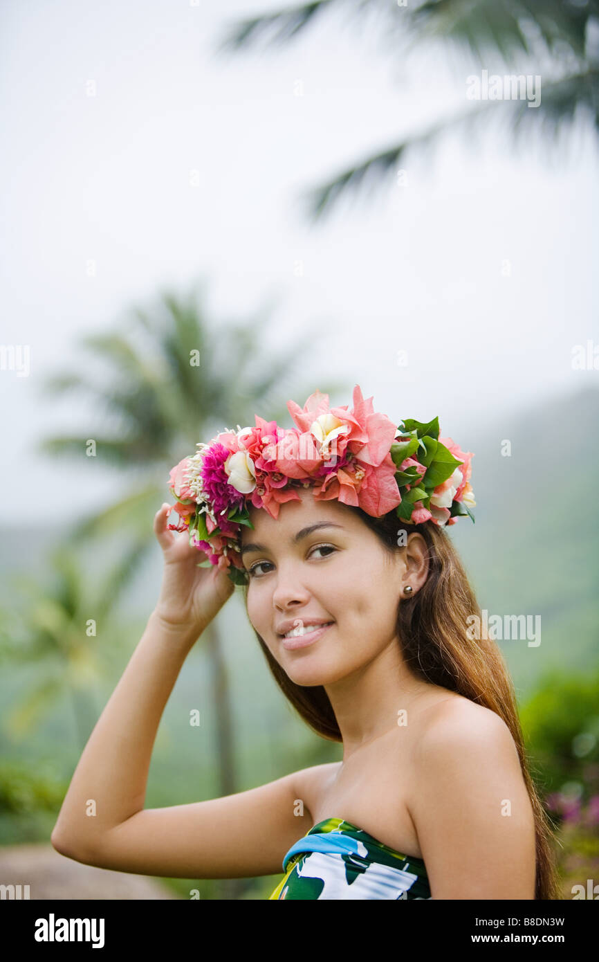 Young woman with flowers in hair in moorea Stock Photo - Alamy