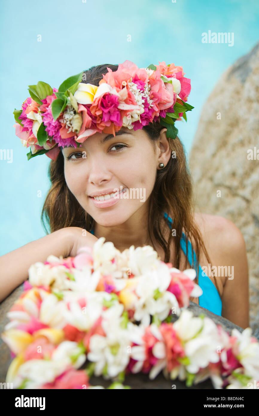 Young woman with flowers in hair in moorea Stock Photo - Alamy