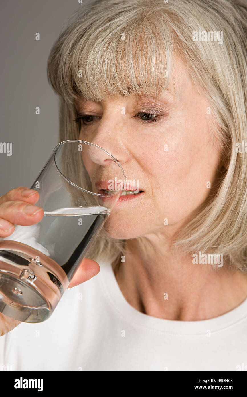 Senior woman drinking water Stock Photo - Alamy