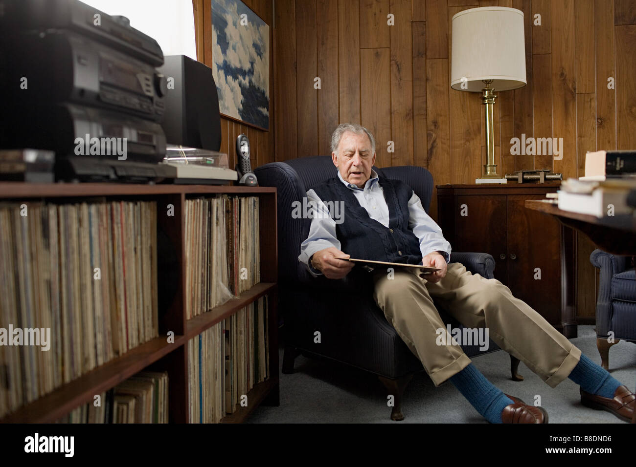 Senior man looking at a vinyl record Stock Photo - Alamy