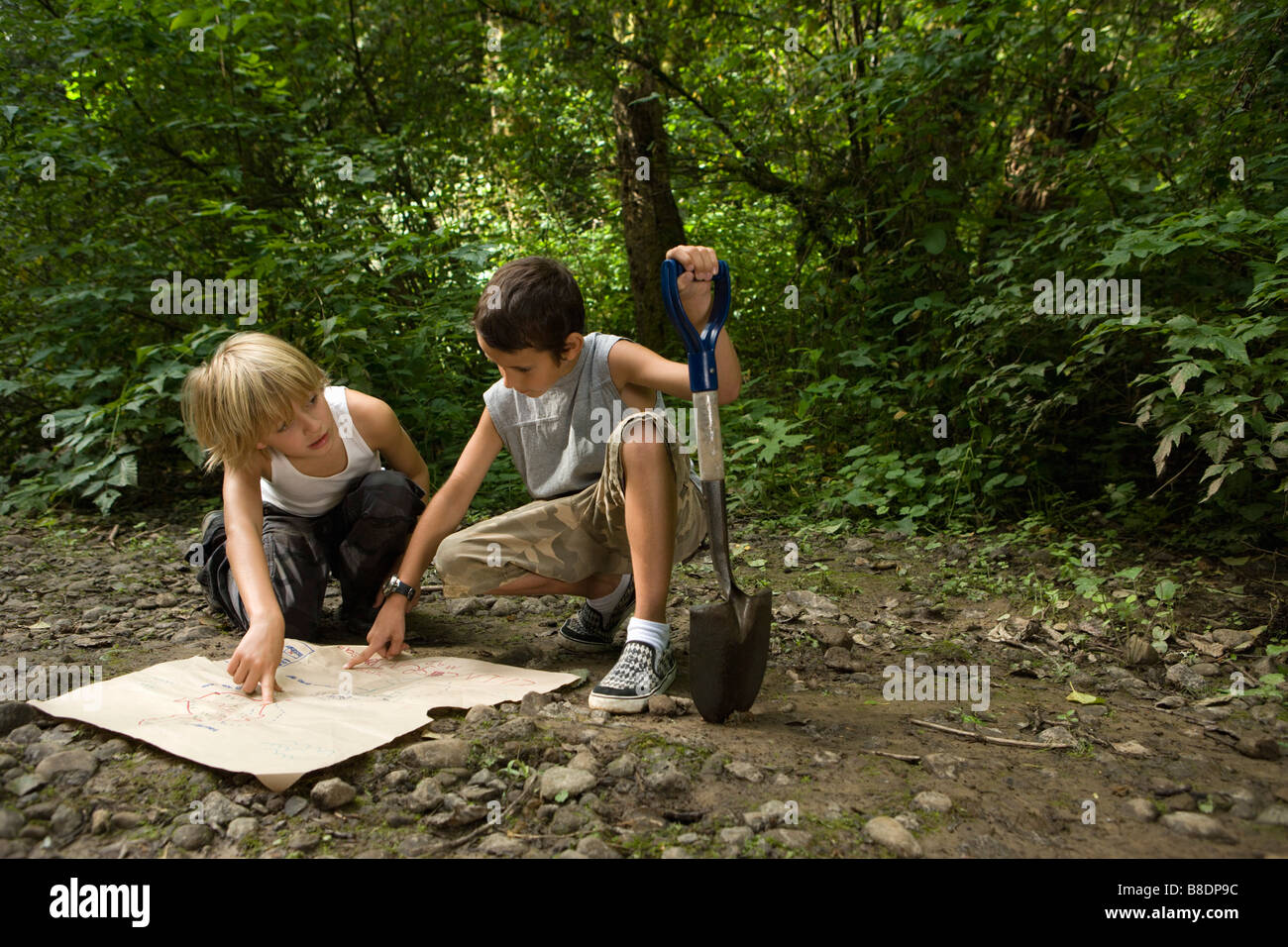 Boys looking at map Stock Photo - Alamy