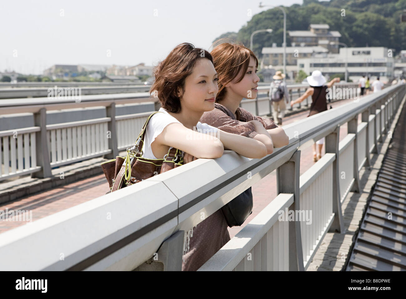 Young women on bridge Stock Photo - Alamy