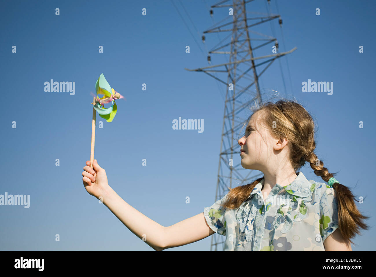 Girl by pylon with pinwheel Stock Photo - Alamy