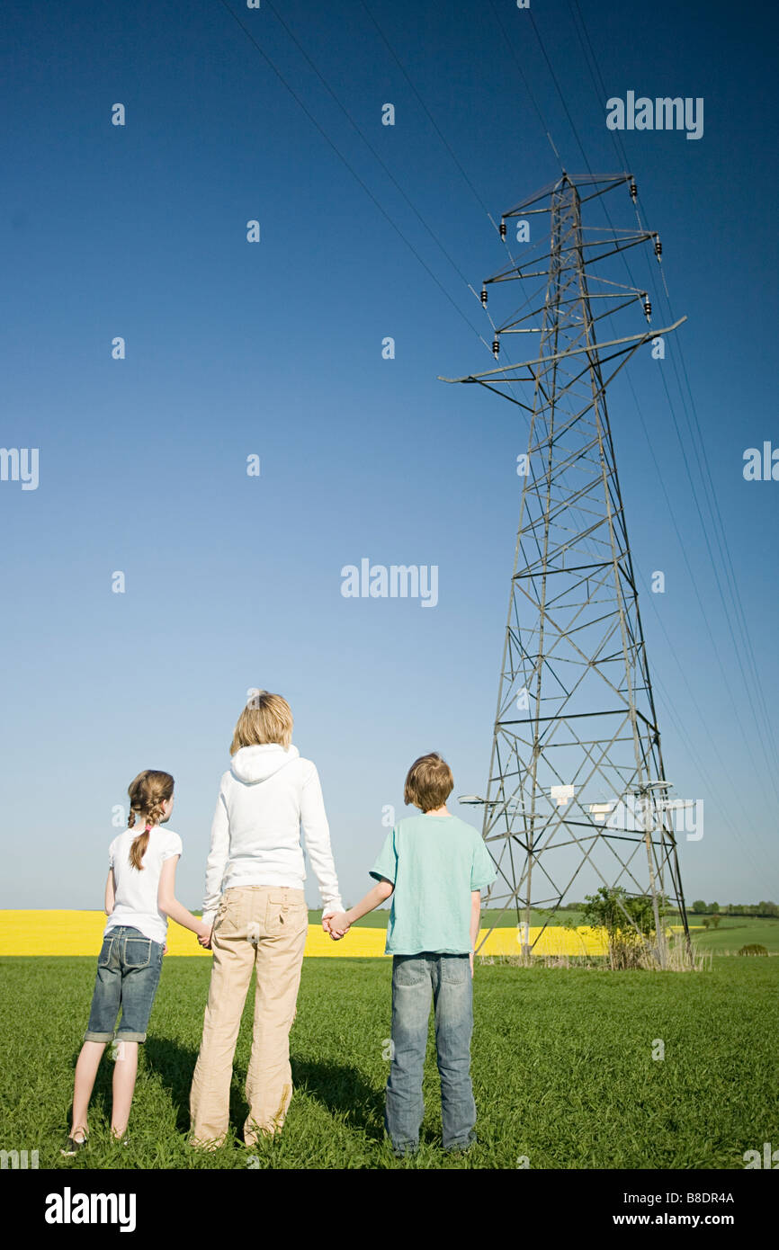Mother and children by pylon Stock Photo - Alamy