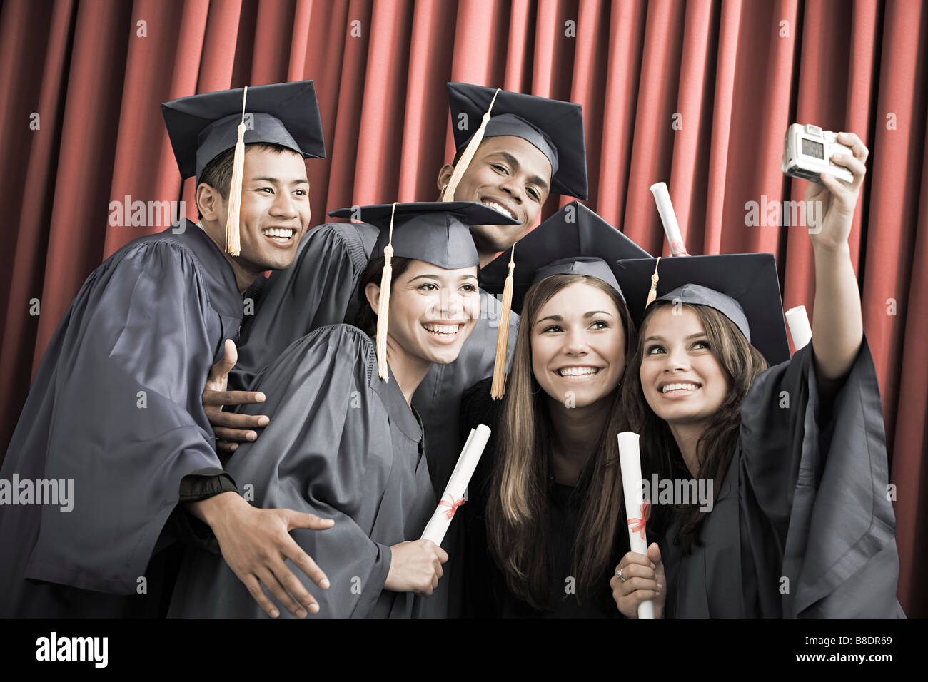 Graduating friends with camera Stock Photo - Alamy