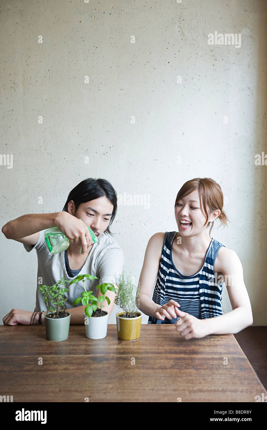 Couple looking flower pots hi-res stock photography and images - Alamy