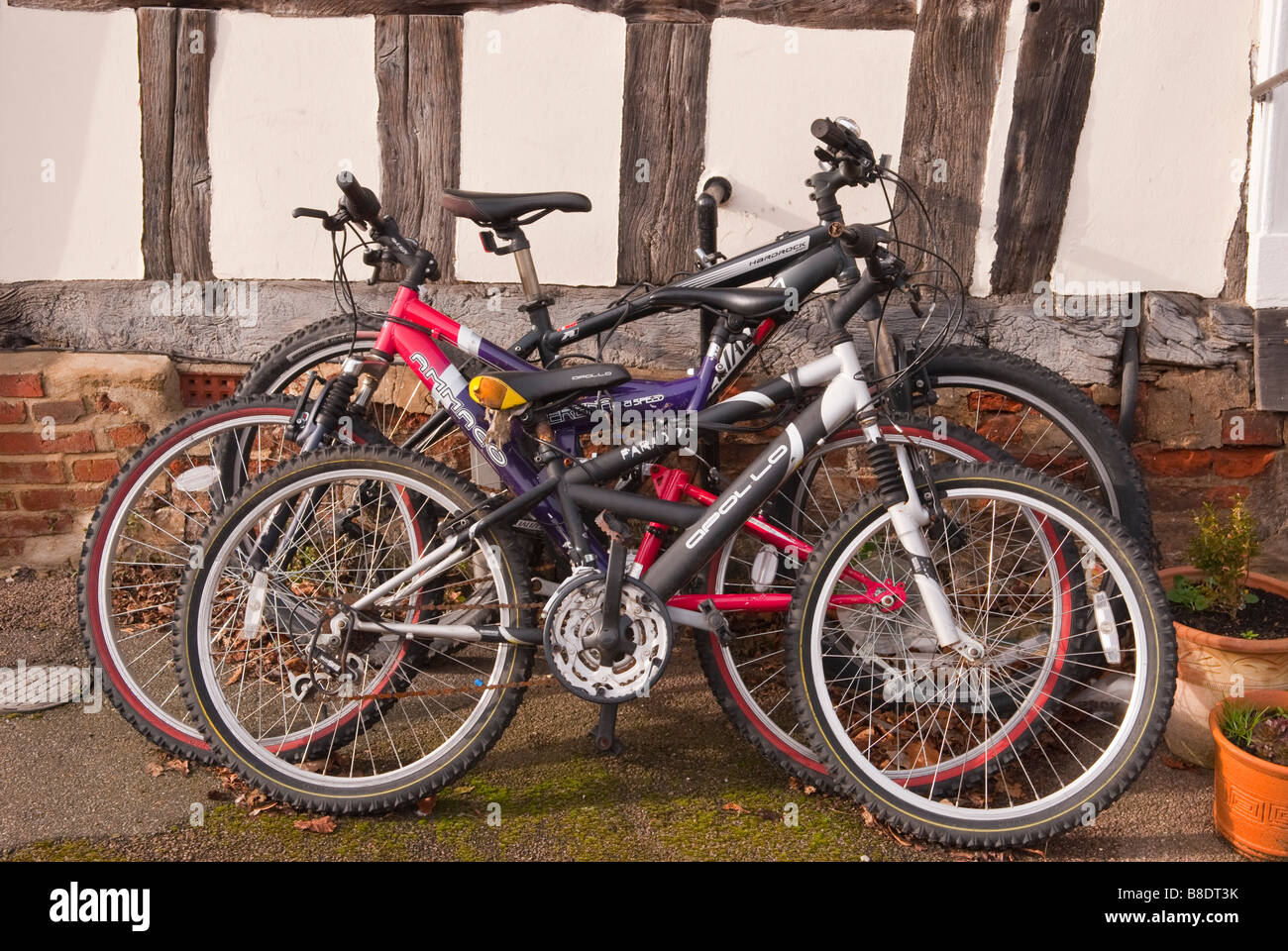 Three bikes locked up together for security outside a house Stock Photo ...