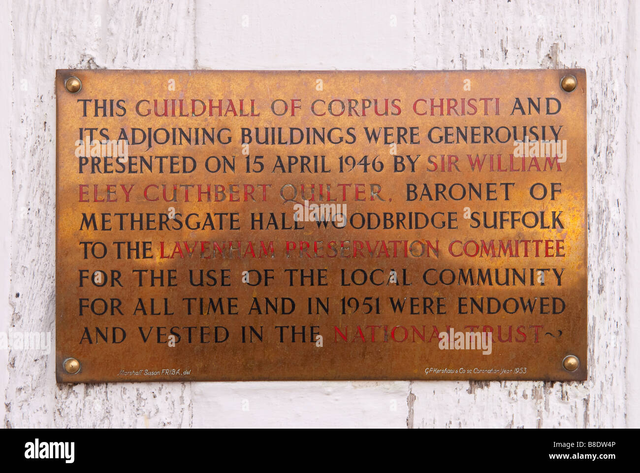 A metal plaque sign with information about the guildhall in Lavenham ...