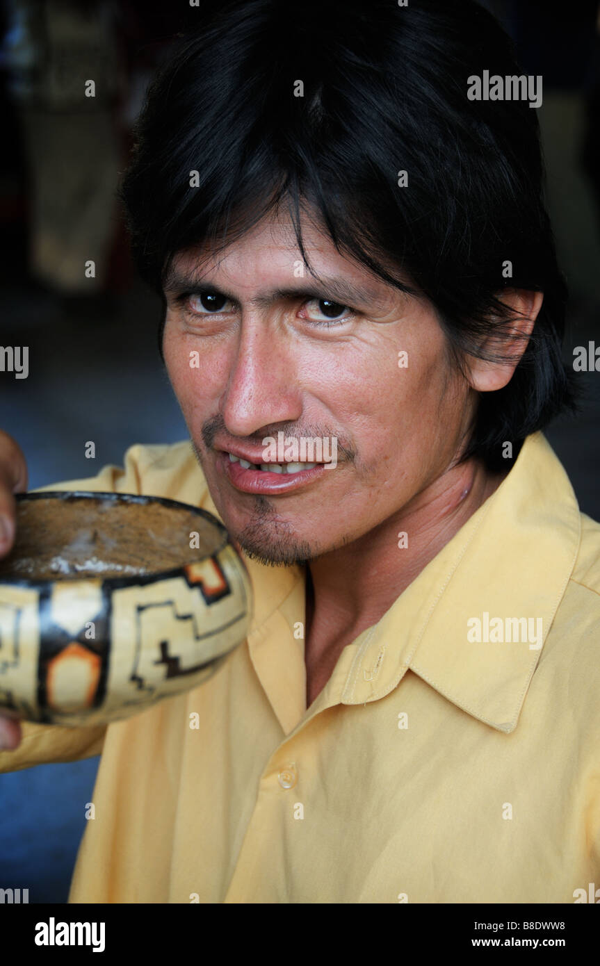 A mestizo man offers a drink at a festival in Peru Stock Photo - Alamy