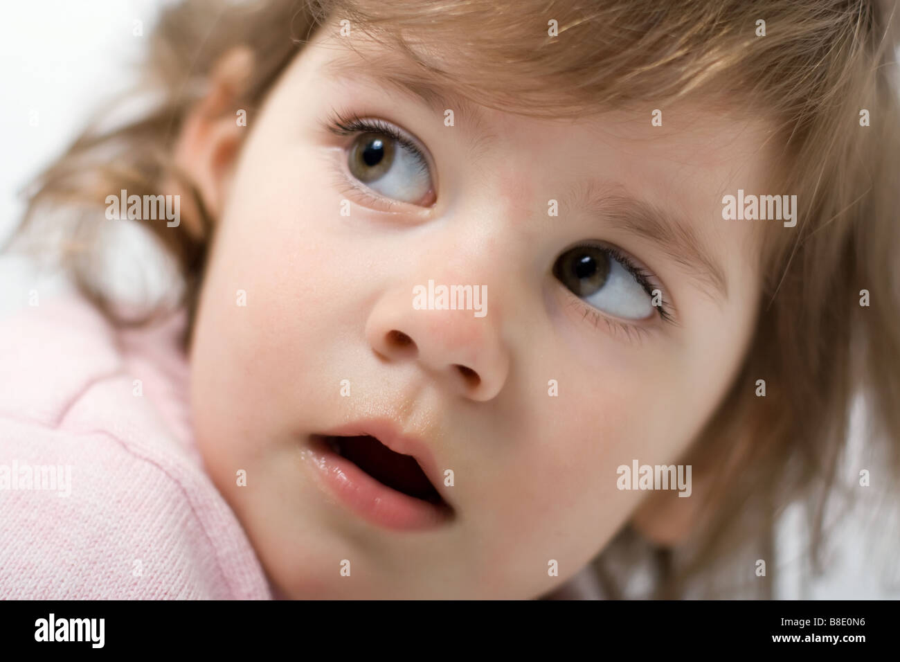 little girl looking over shoulder with open mouth Stock Photo - Alamy