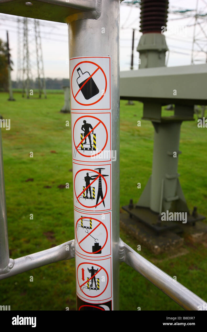Signs at a high voltage line Stock Photo - Alamy
