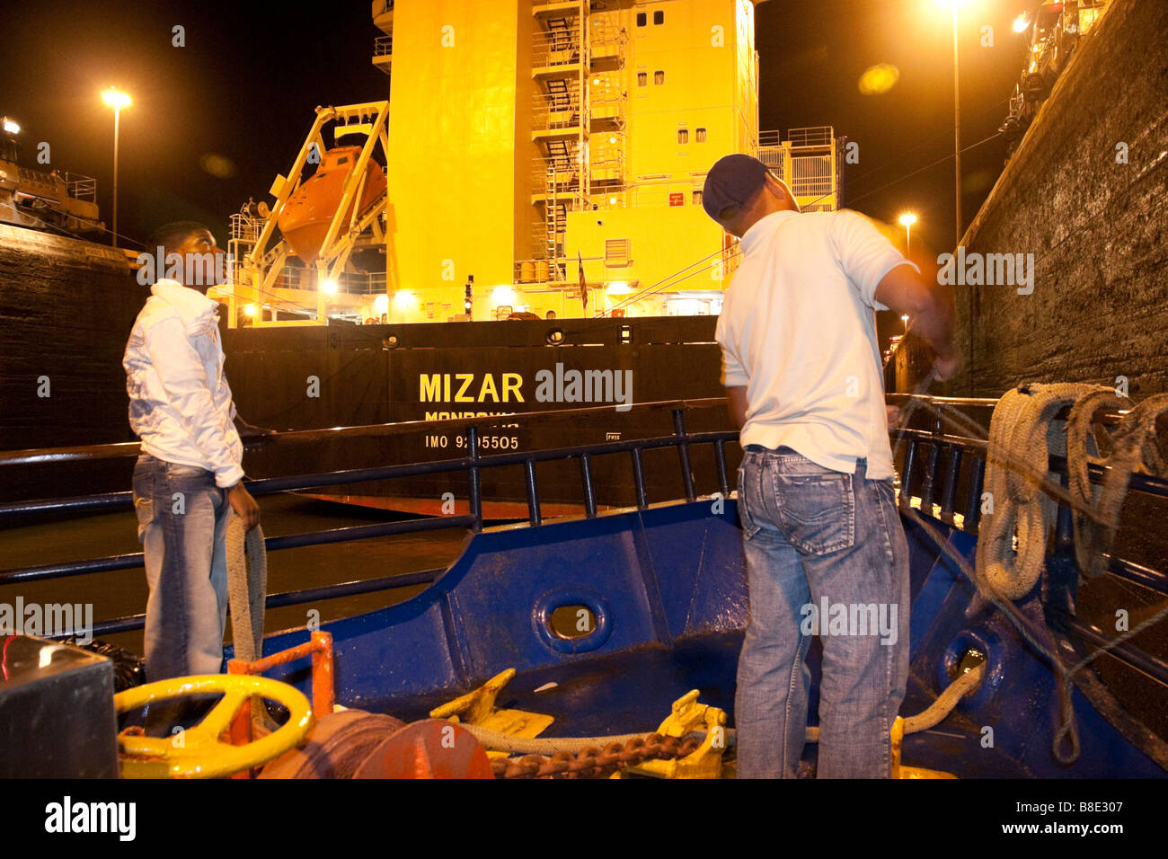 A pair of young helping hands receive the ropes to tie the ship to the ...