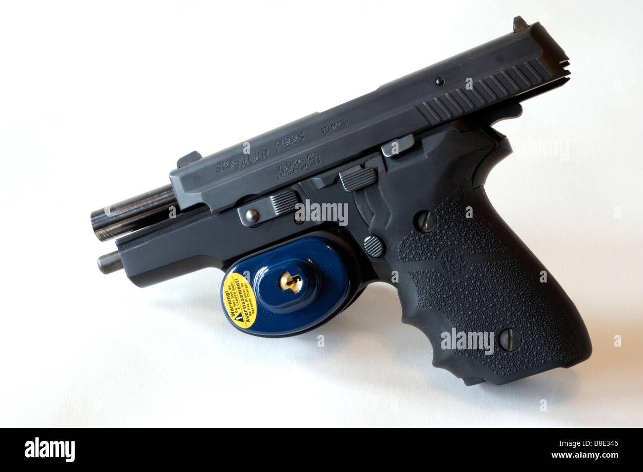 Silhouetted Sig Sauer 229 pistol against a white background with a gun ...