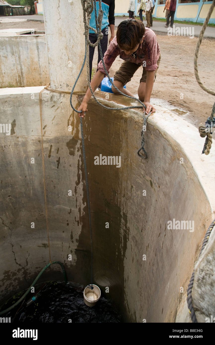 Child drawing water from well hi-res stock photography and images - Alamy
