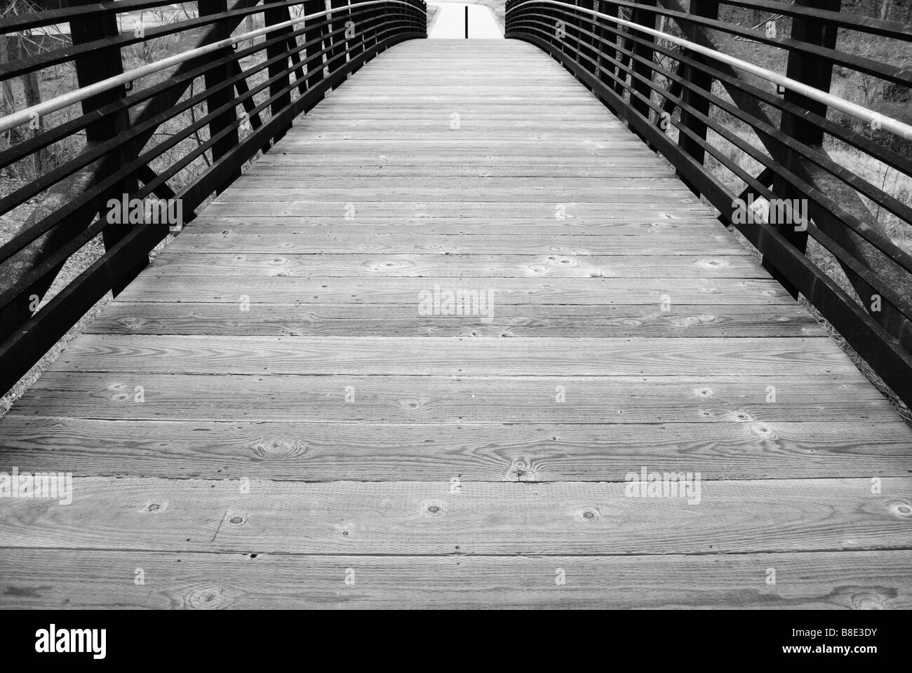 Wooden bridge with metal handrails in Central Park in downtown Durham ...