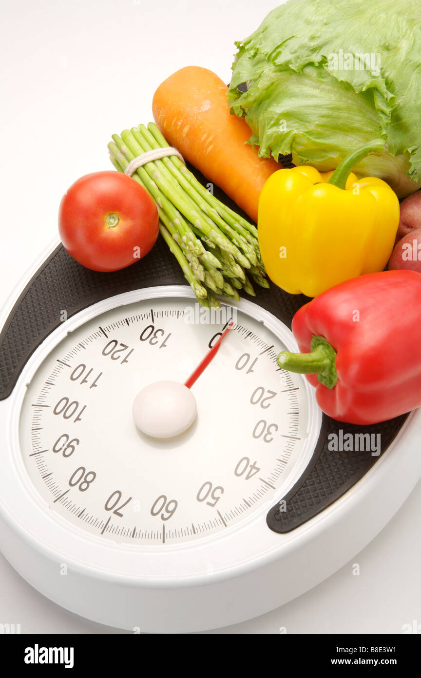 Different kinds of vegetables on the weight scale Stock Photo - Alamy