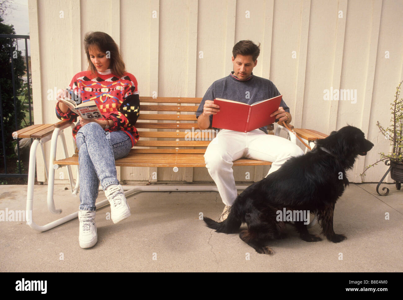couple sit apart on outdoor bench with black dog ANGRY- SEE NEXT IMAGE ...