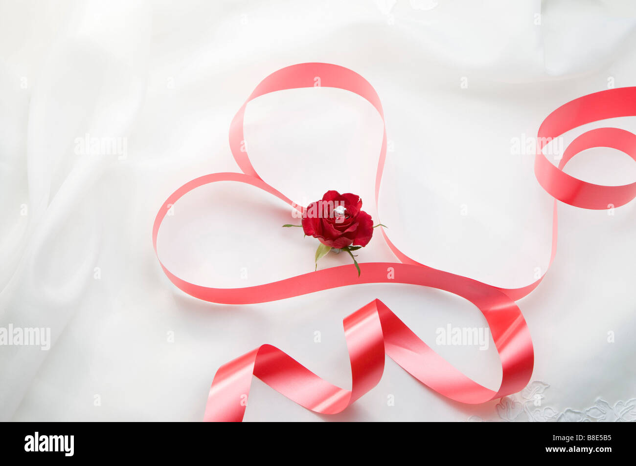 Heart shape created using red ribbon single rose in the heart Stock ...