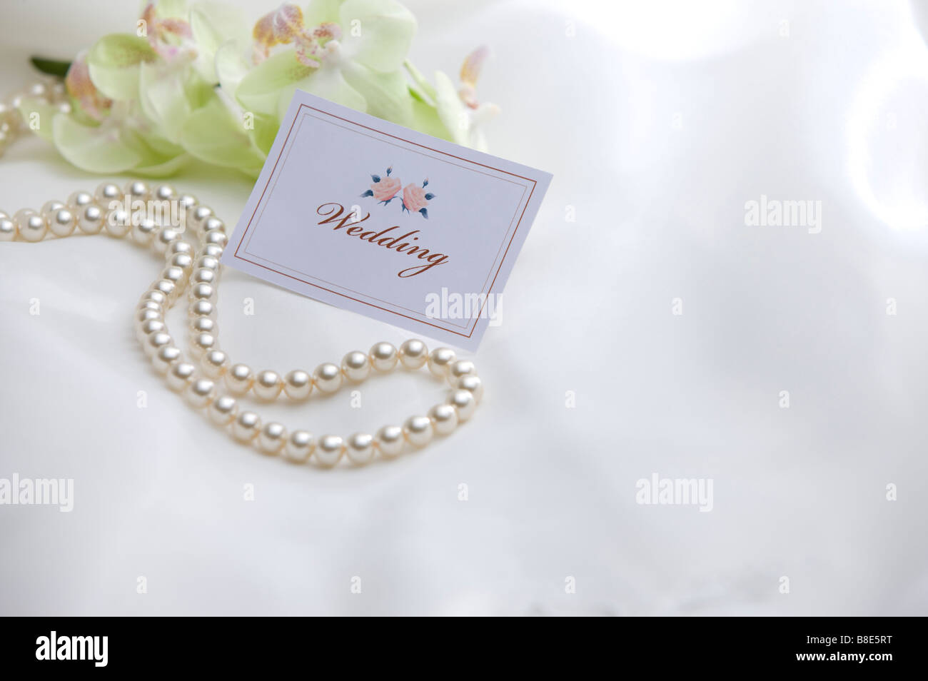 Wedding name tag and pearl necklace on fabric Stock Photo - Alamy
