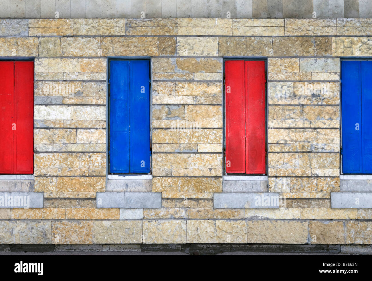 Four closed metal window shutters over stone covered wall Stock Photo ...