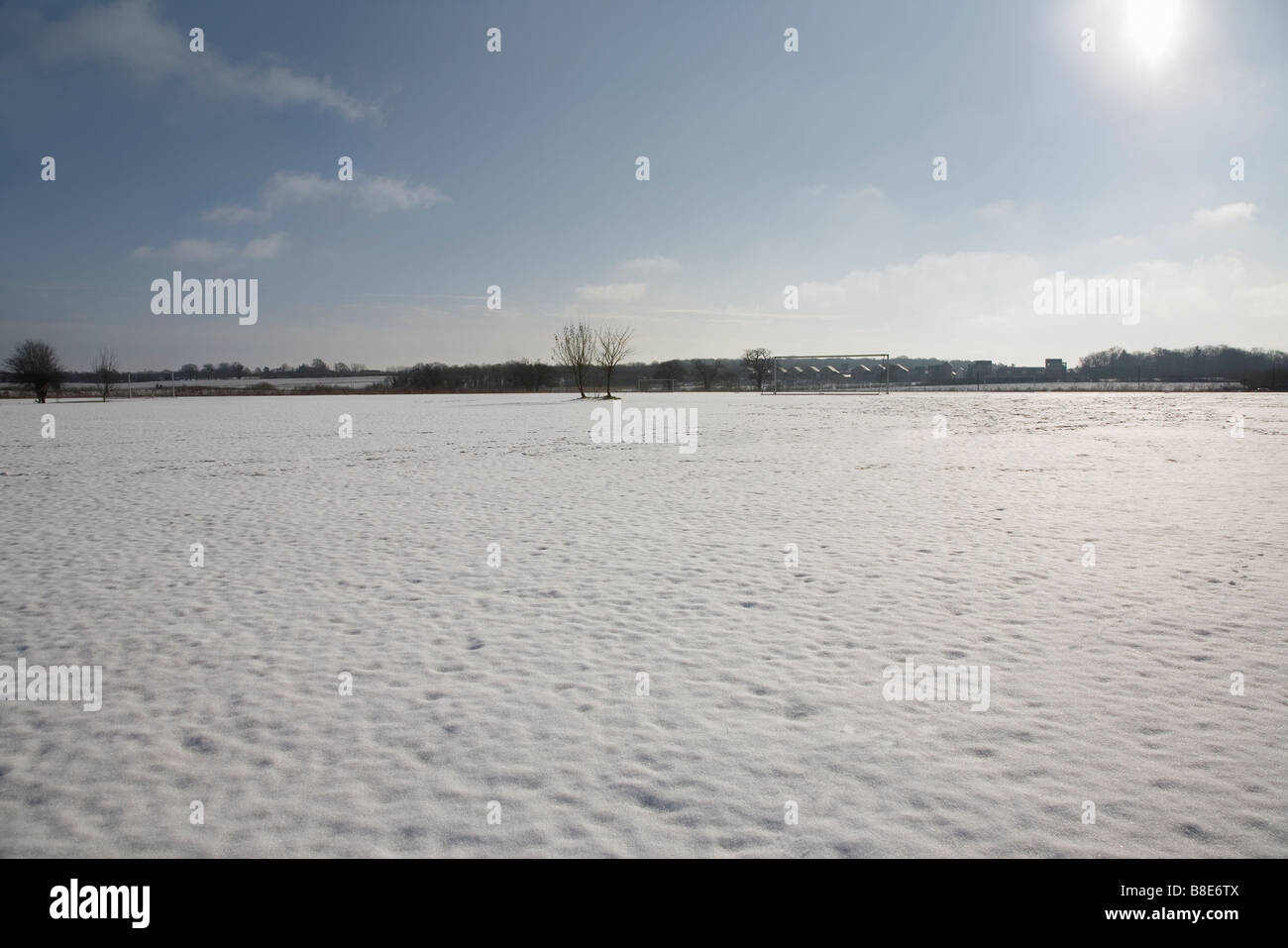 winter snow scene showing a snow covered sports field with football ...