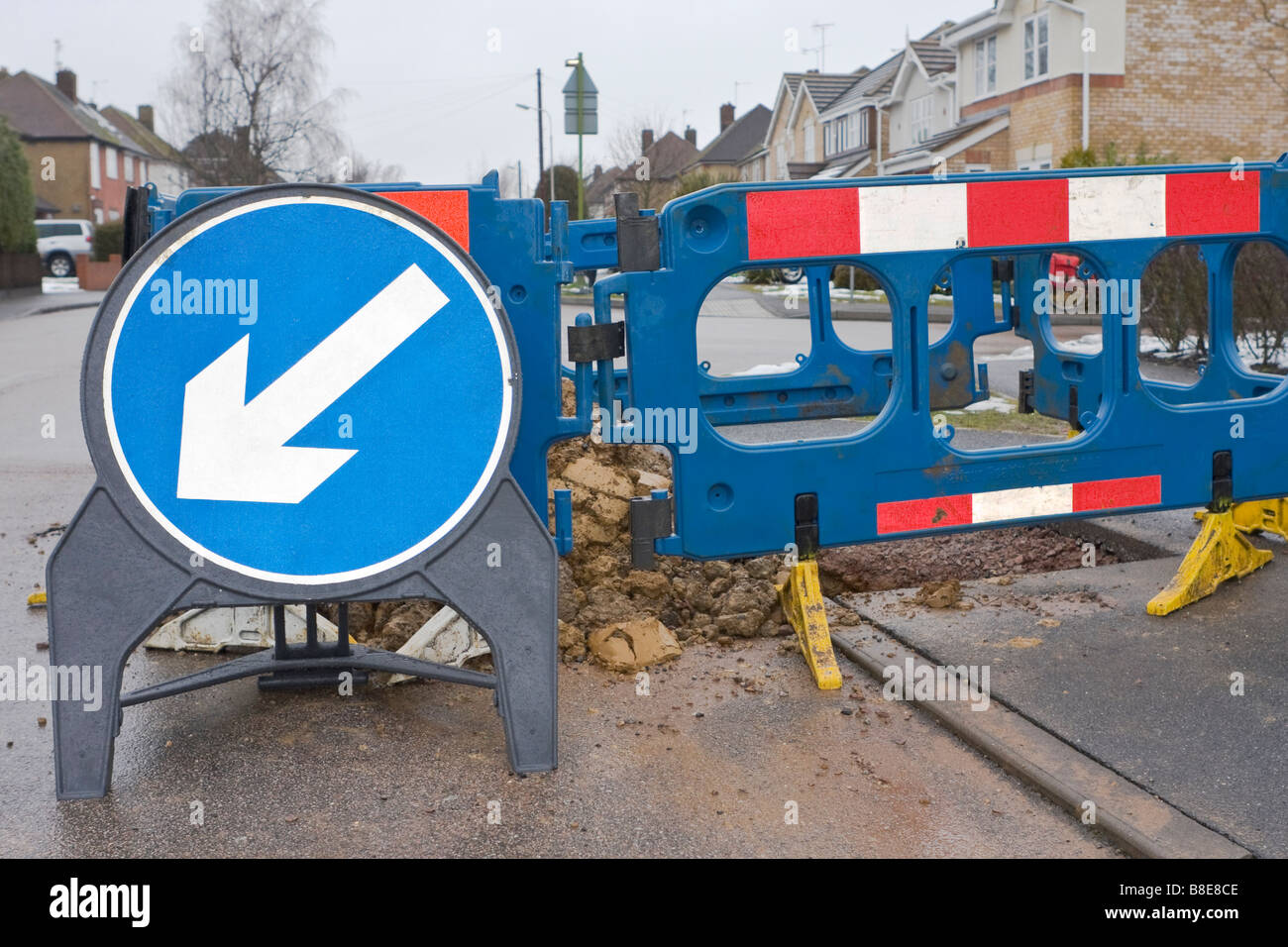 Barriers and signs around a water main repair Stock Photo - Alamy