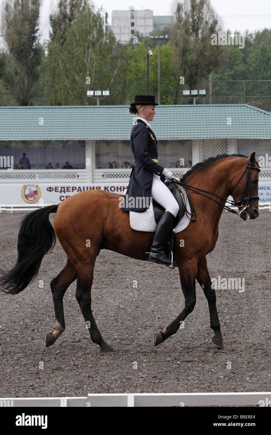 Woman in dressage costume with horse Stock Photo - Alamy