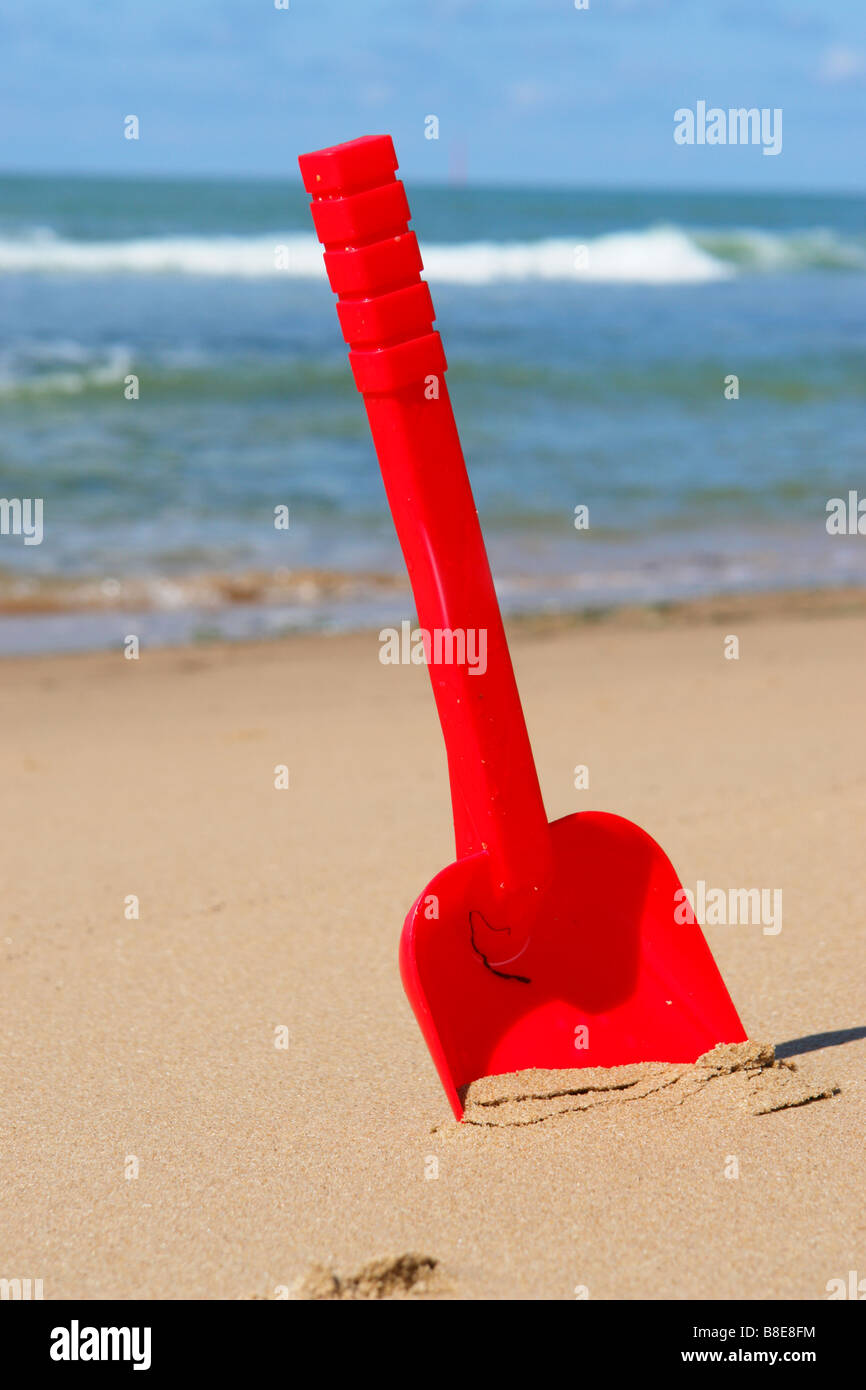 a red shovel at the beach Stock Photo - Alamy