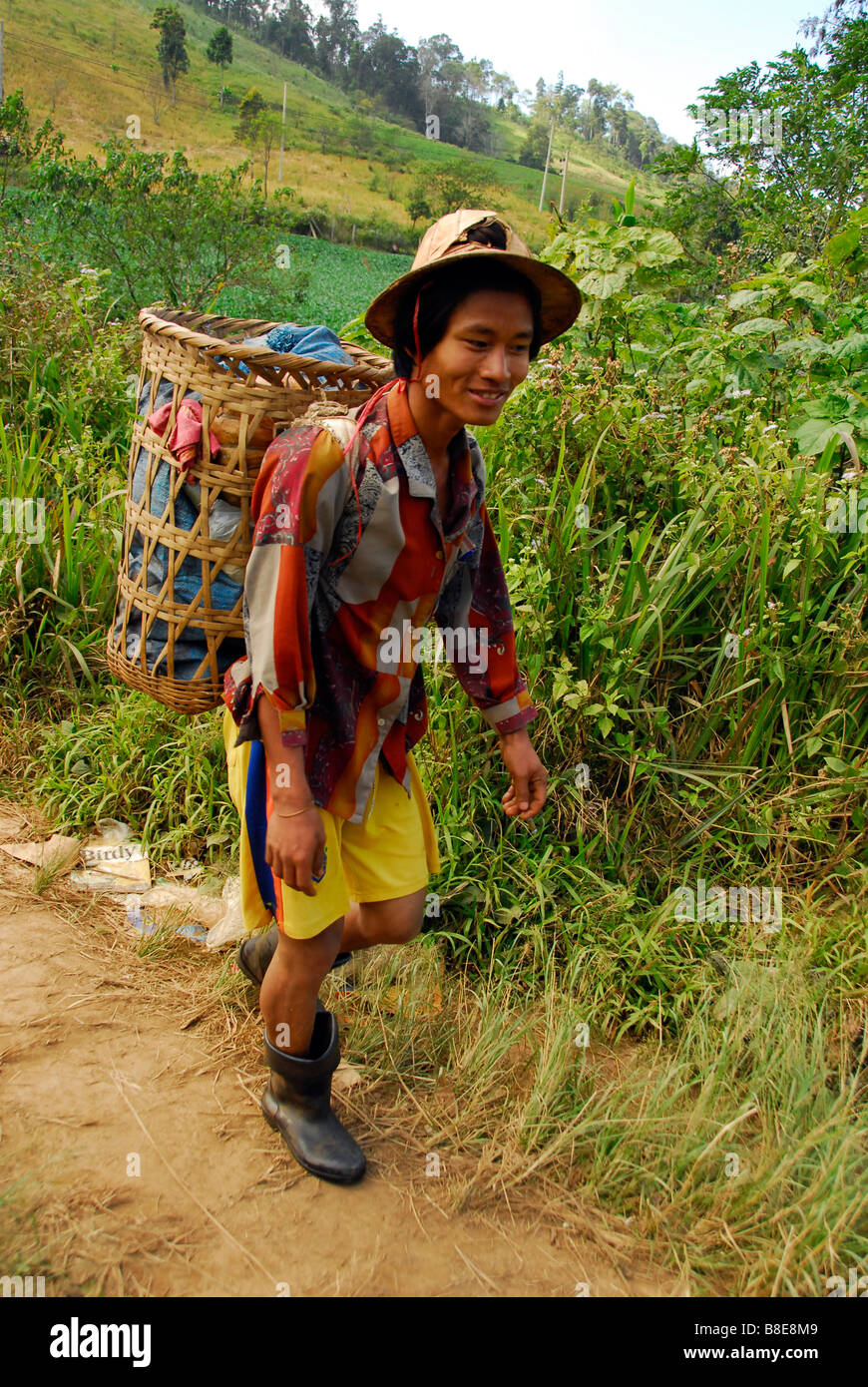 Karen guy carrying clothes on his back to wash in the river,Tak ...