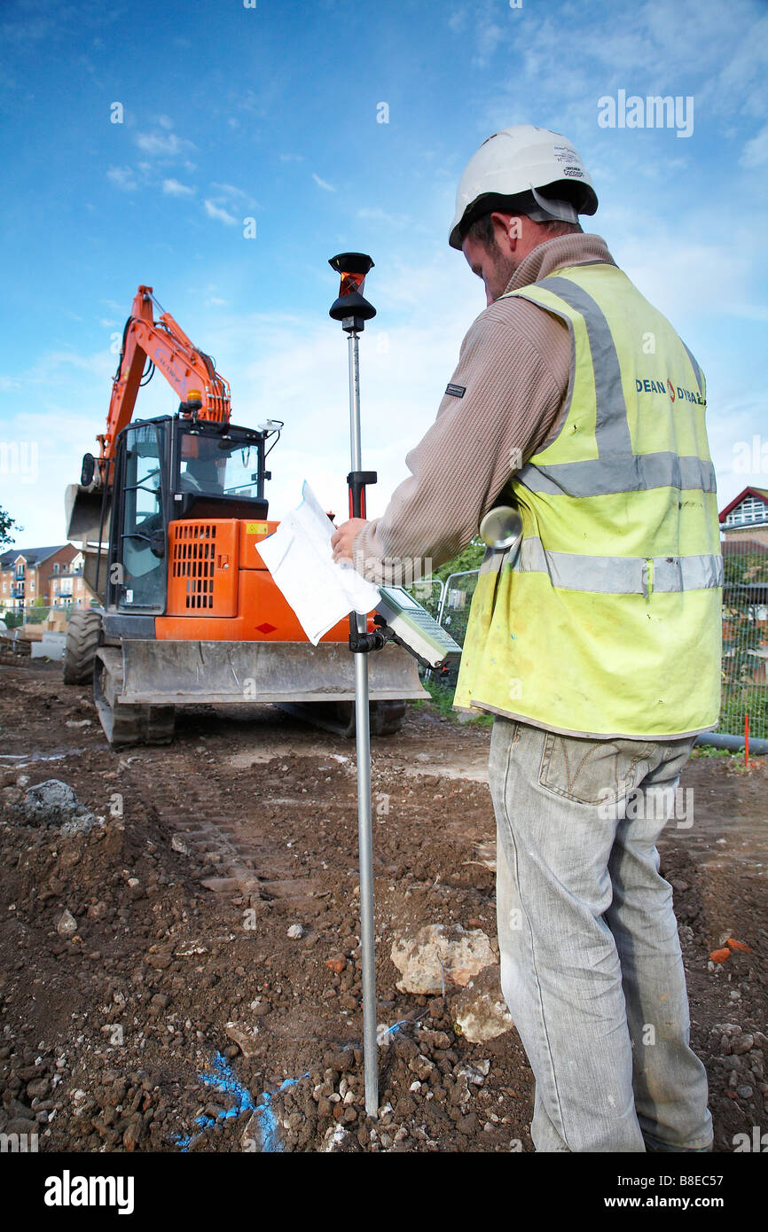 Workman Taking measurements at building site Stock Photo - Alamy