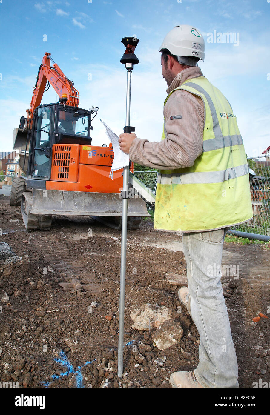 Workman Taking measurements at building site Stock Photo - Alamy