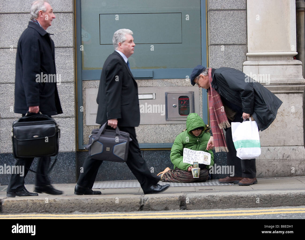 Woman giving beggar street uk hi-res stock photography and images - Alamy