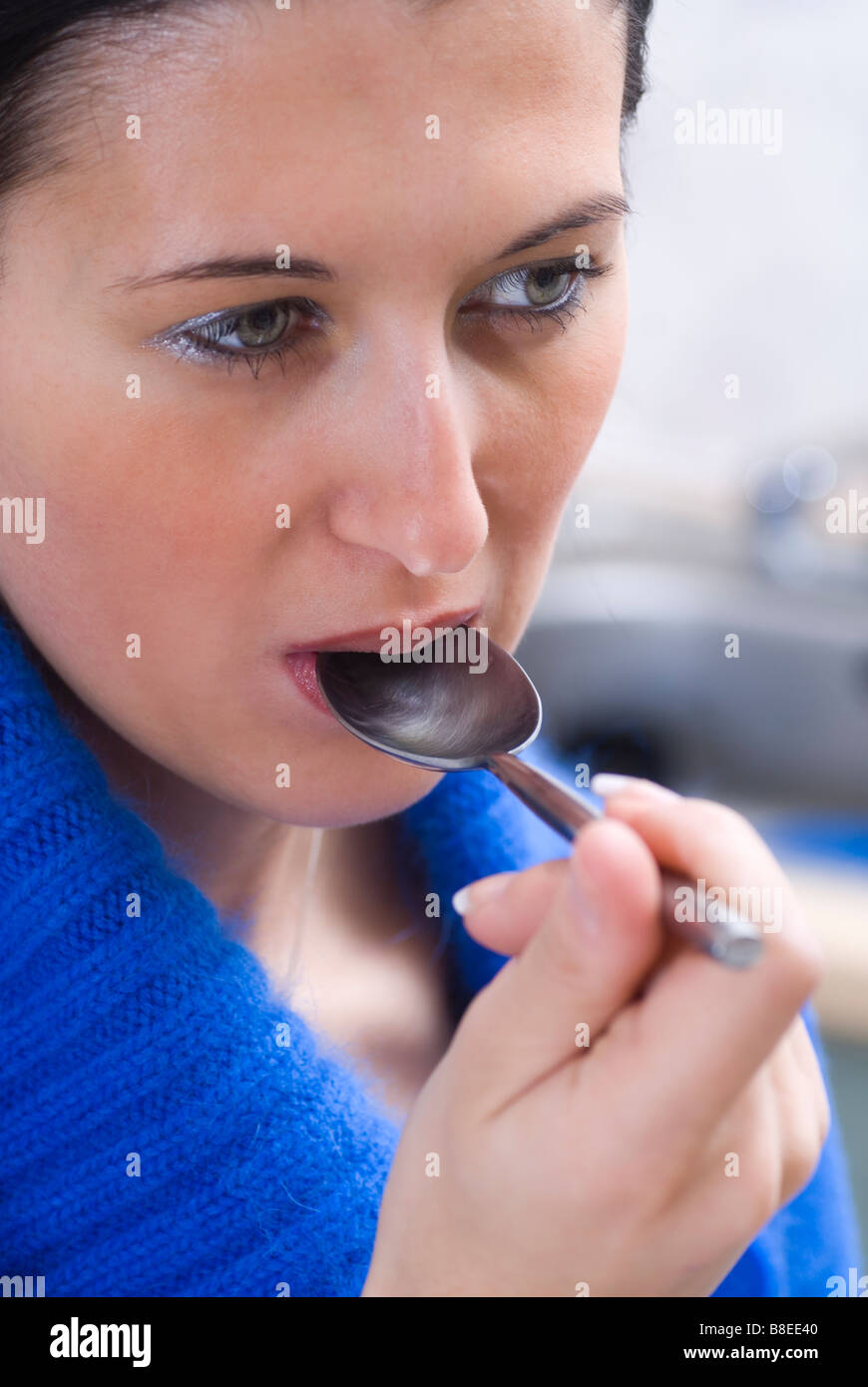 Woman eating with a spoon Stock Photo - Alamy