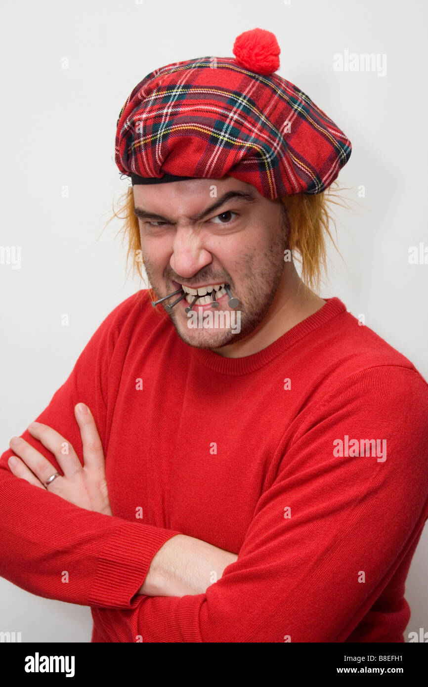 Angry Scotsman chewing nails Stock Photo - Alamy