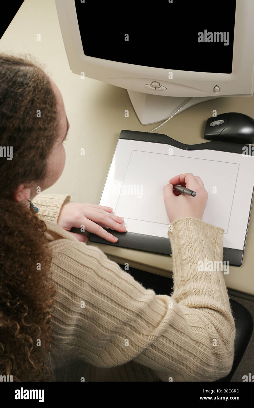 A vertical view of a girl working on a computer graphics tablet Stock ...