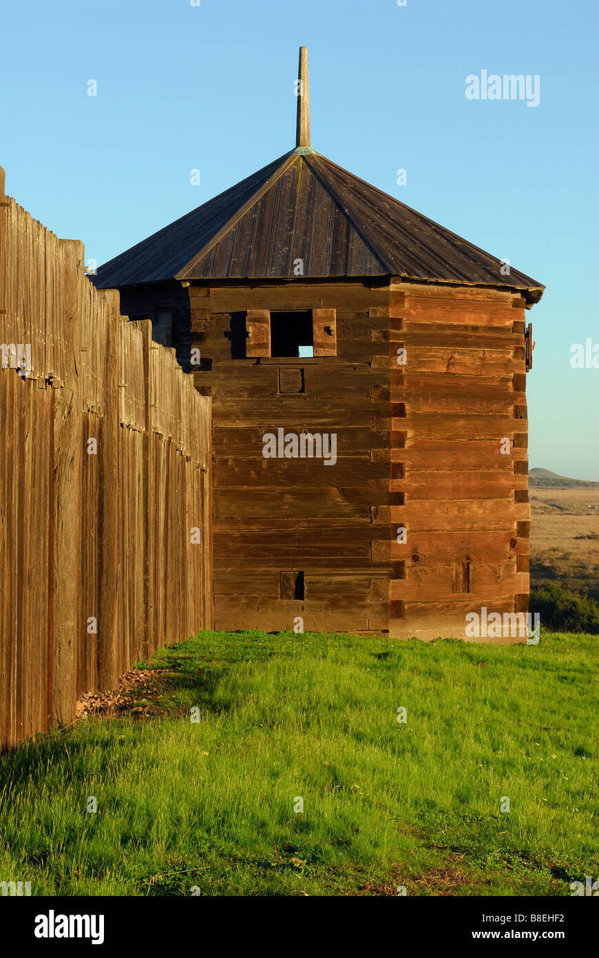 fort ross tower and wood palissade green grass and blue sky background ...