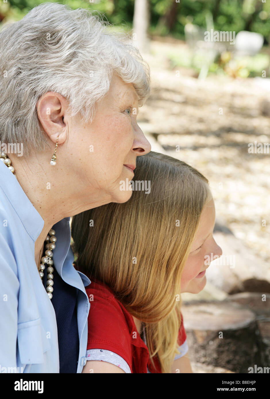 Profile of grandmother in the park with her granddaughter There is a ...