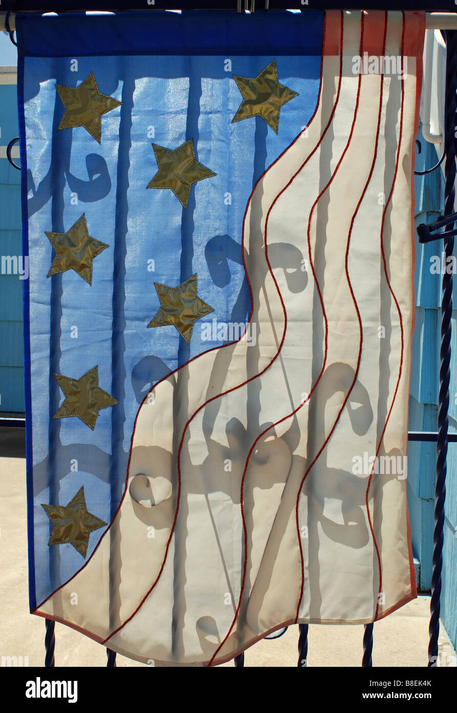 Playful shadows fall on a pastel flag and gate 4 Stock Photo - Alamy