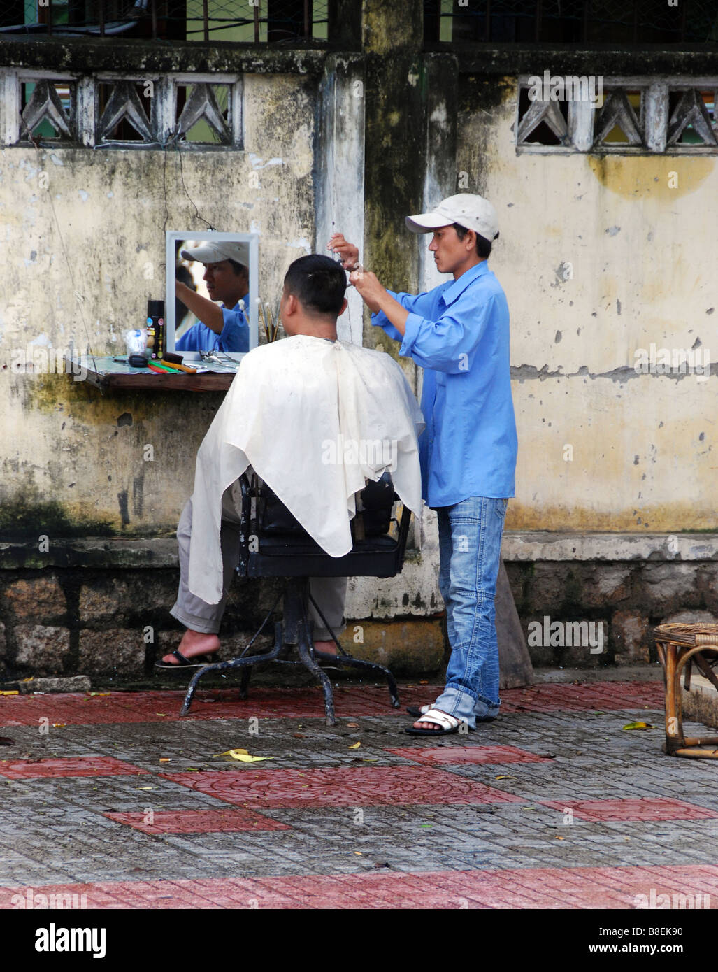 Open air haircut in Vietnam - barber and customer in Nha Trang street ...