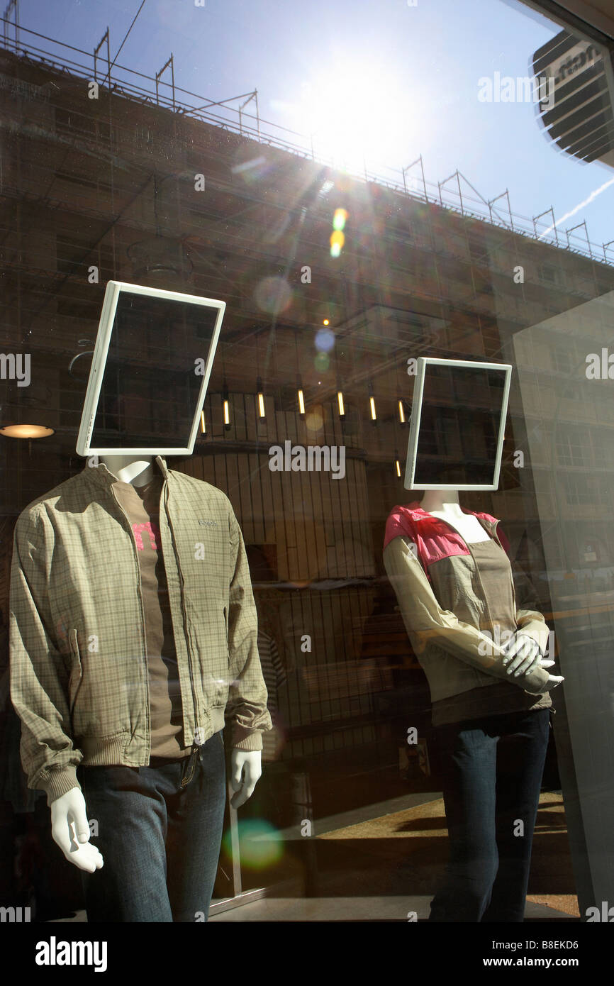 Mannequins with a screen instead of a head in a shop window, Berlin ...