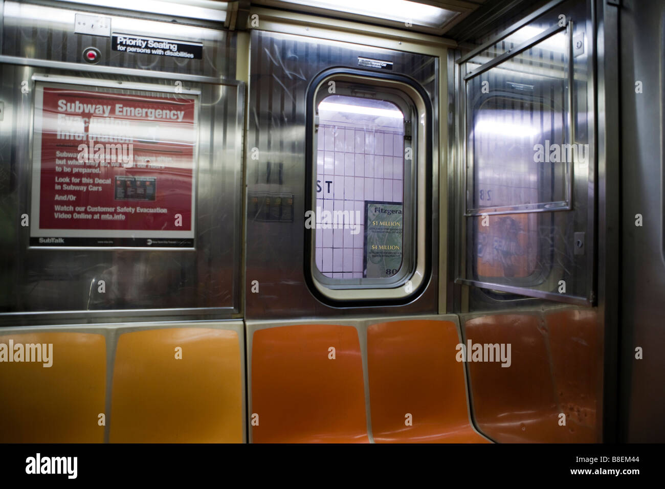 Row of yellow seats inside a New York subway train Stock Photo - Alamy
