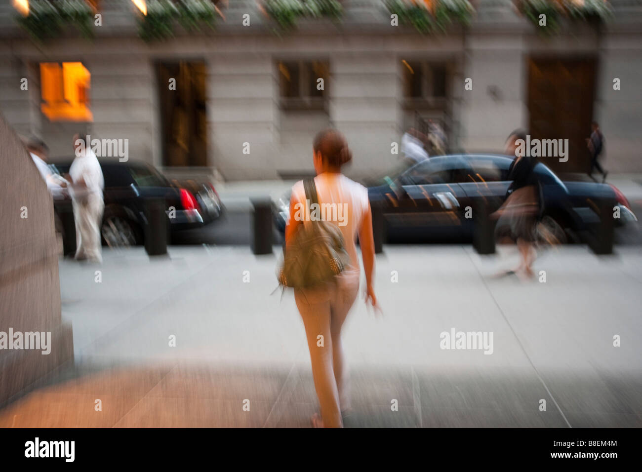 Young woman walking out of a building Stock Photo - Alamy