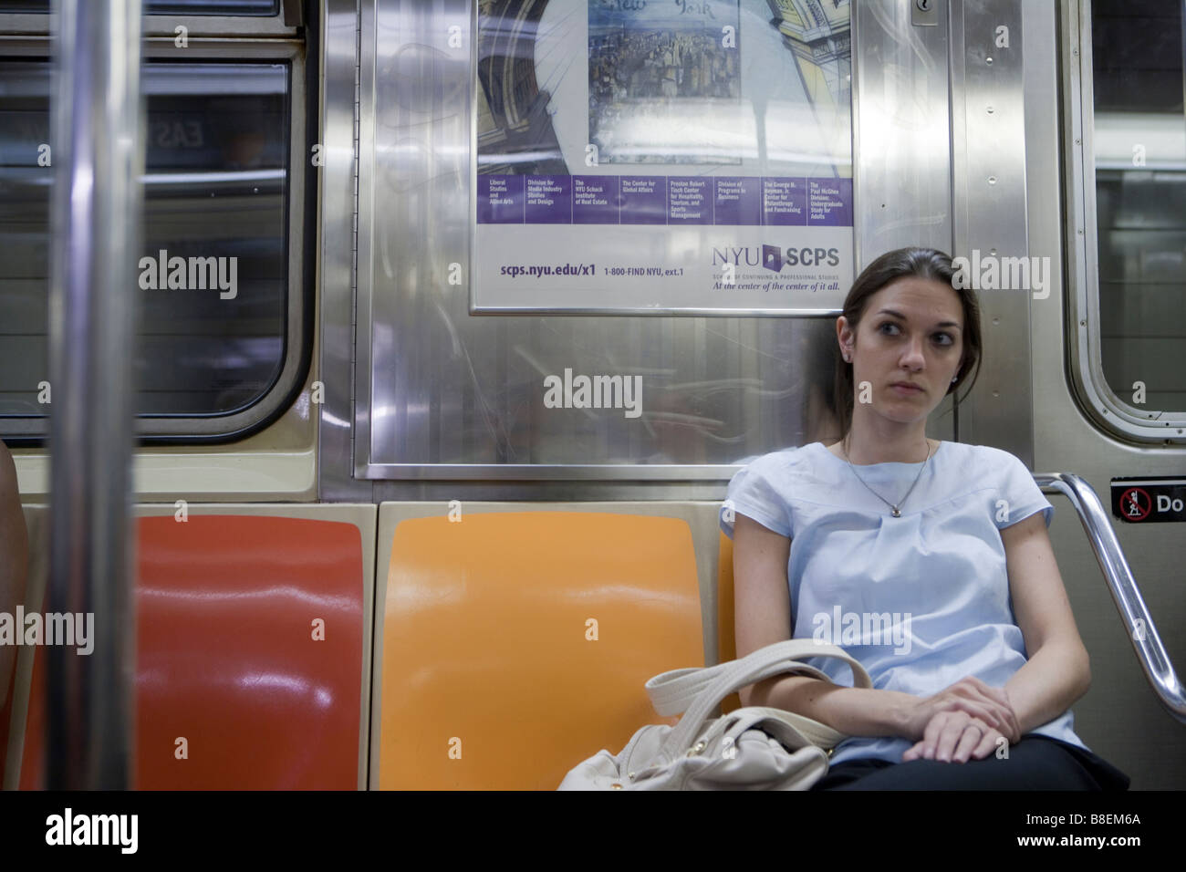 woman sitting on the chairs of the subway looking tired in the new york ...