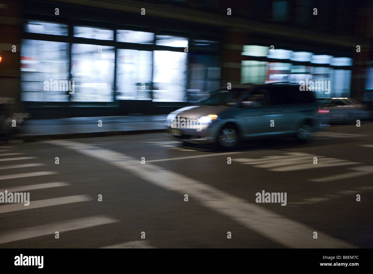 black car passing by during night time Stock Photo - Alamy