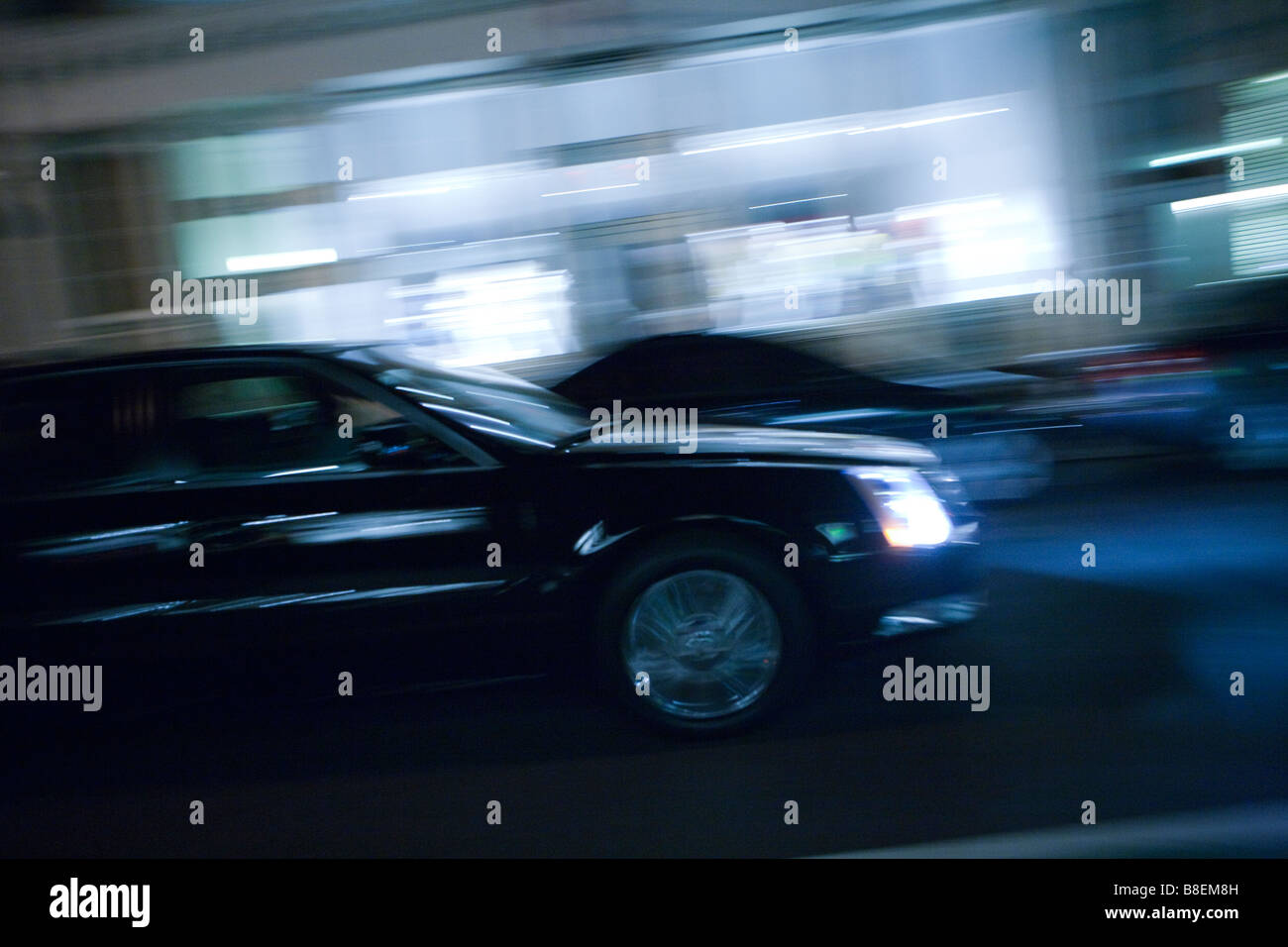 black car passing by during night time Stock Photo - Alamy