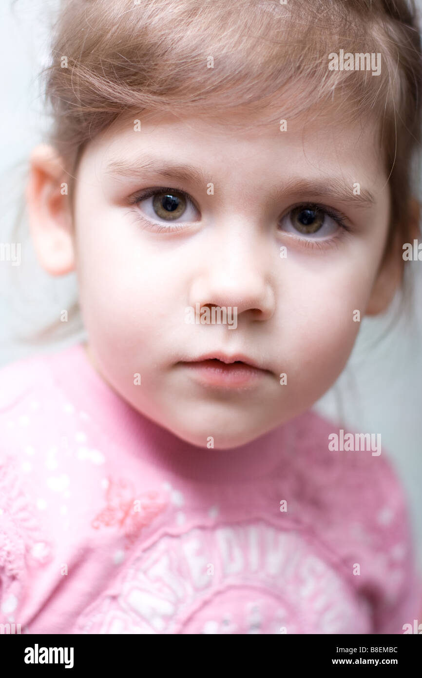 Portrait of a pretty serious little girl Stock Photo - Alamy