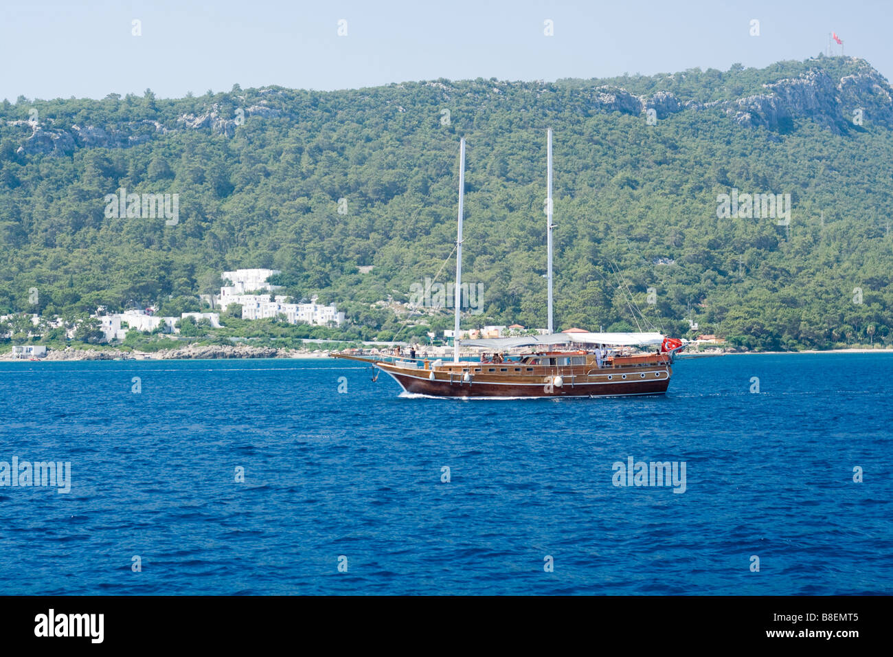 Yacht Beach with mountains in a background Stock Photo - Alamy